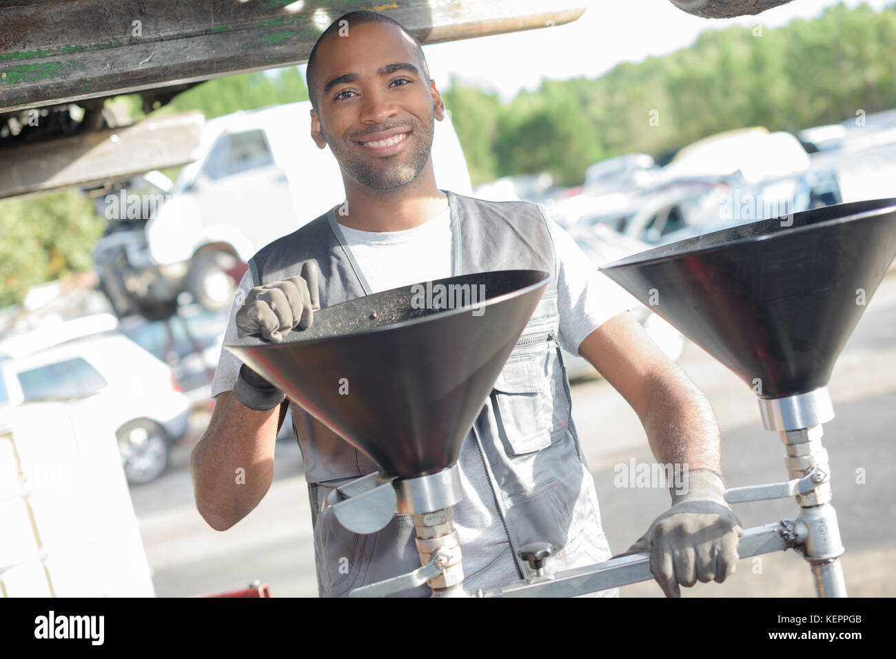 mechanic with big funnels Stock Photo - Alamy