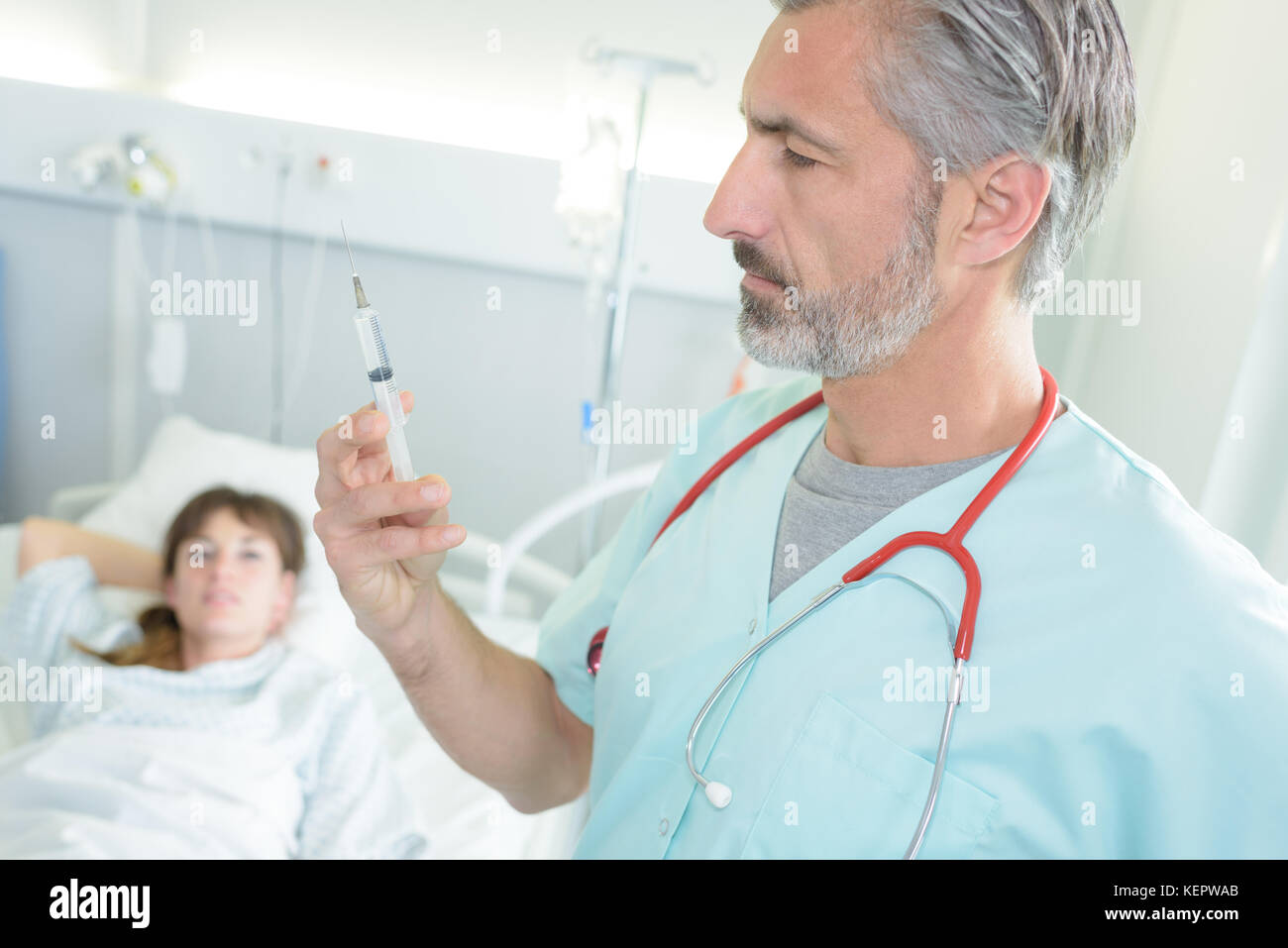 doctor injecting patient with syringe to collect blood Stock Photo - Alamy