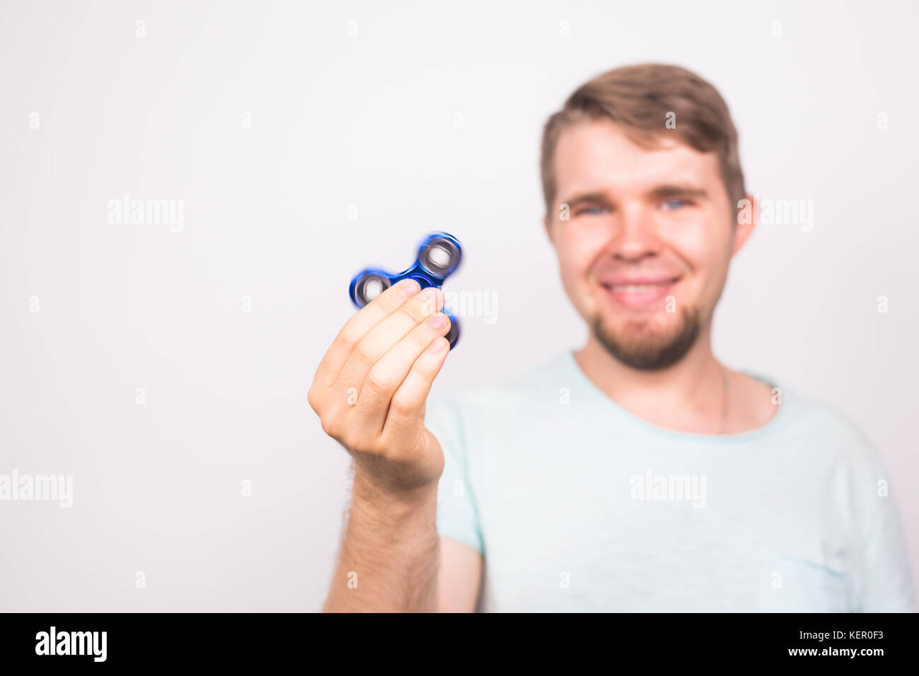 young man playing with a fidget spinner, focus on spinner Stock Photo ...