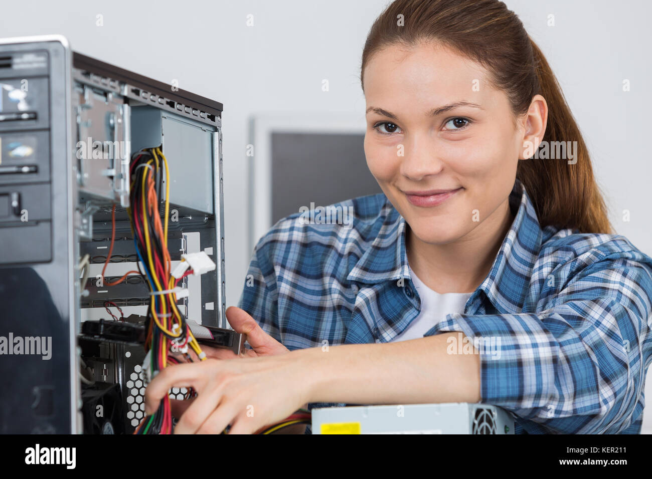 female pc technician posing next to a disassembled desktop computer Stock Photo - Alamy