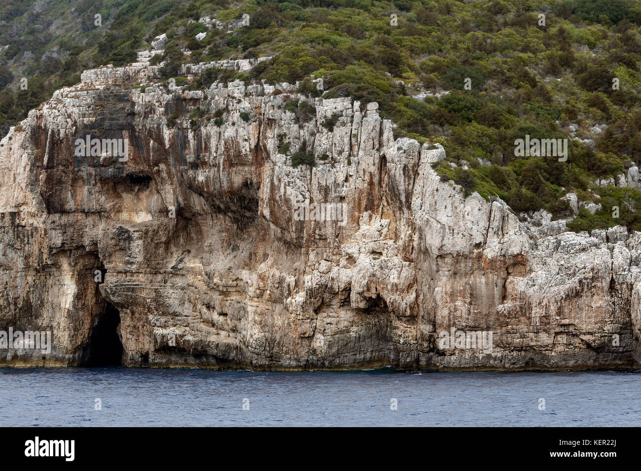 Rock massif with a caves over the Ionian Sea, Greece Stock Photo - Alamy