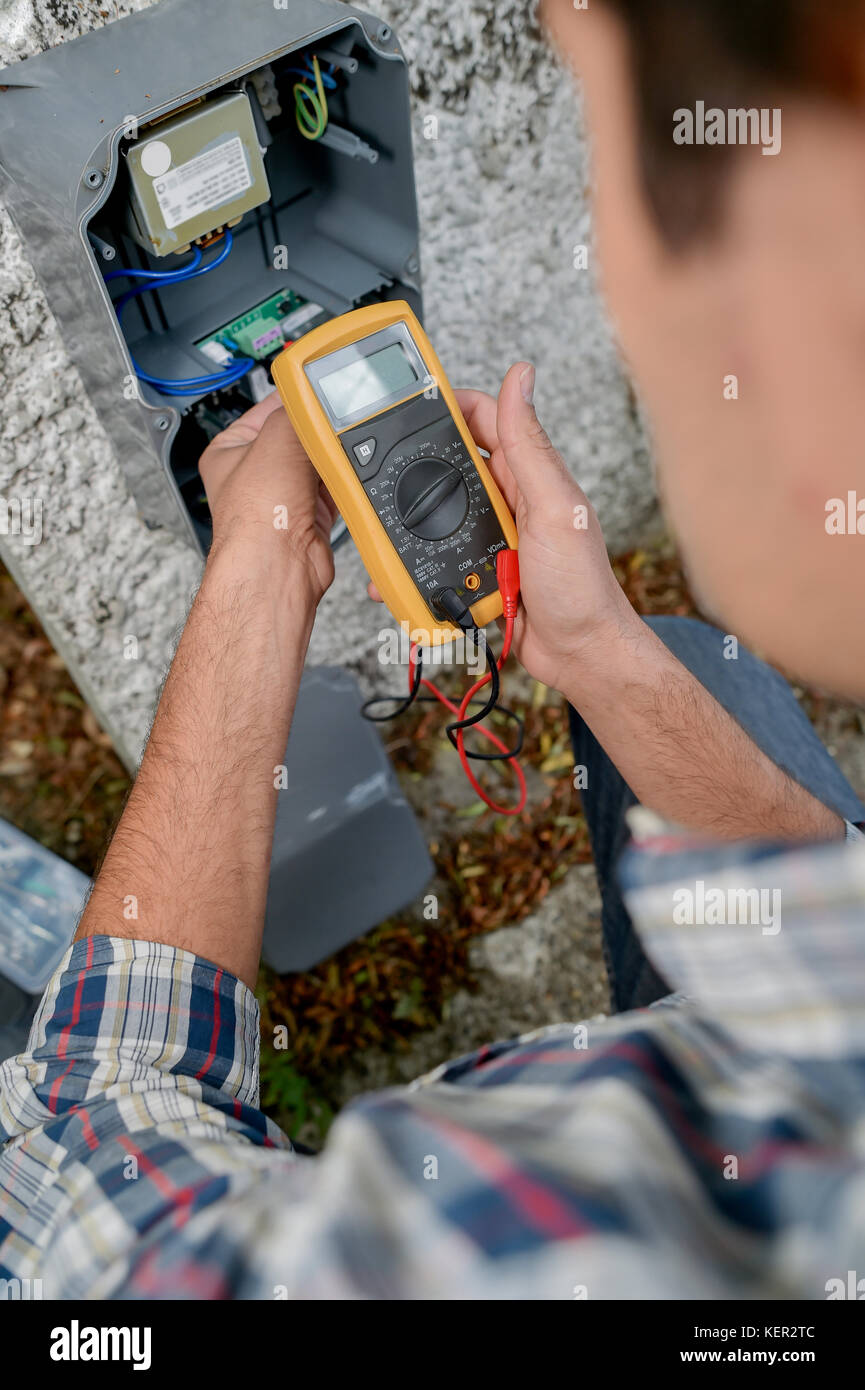 Electrician using a voltmeter device Stock Photo - Alamy