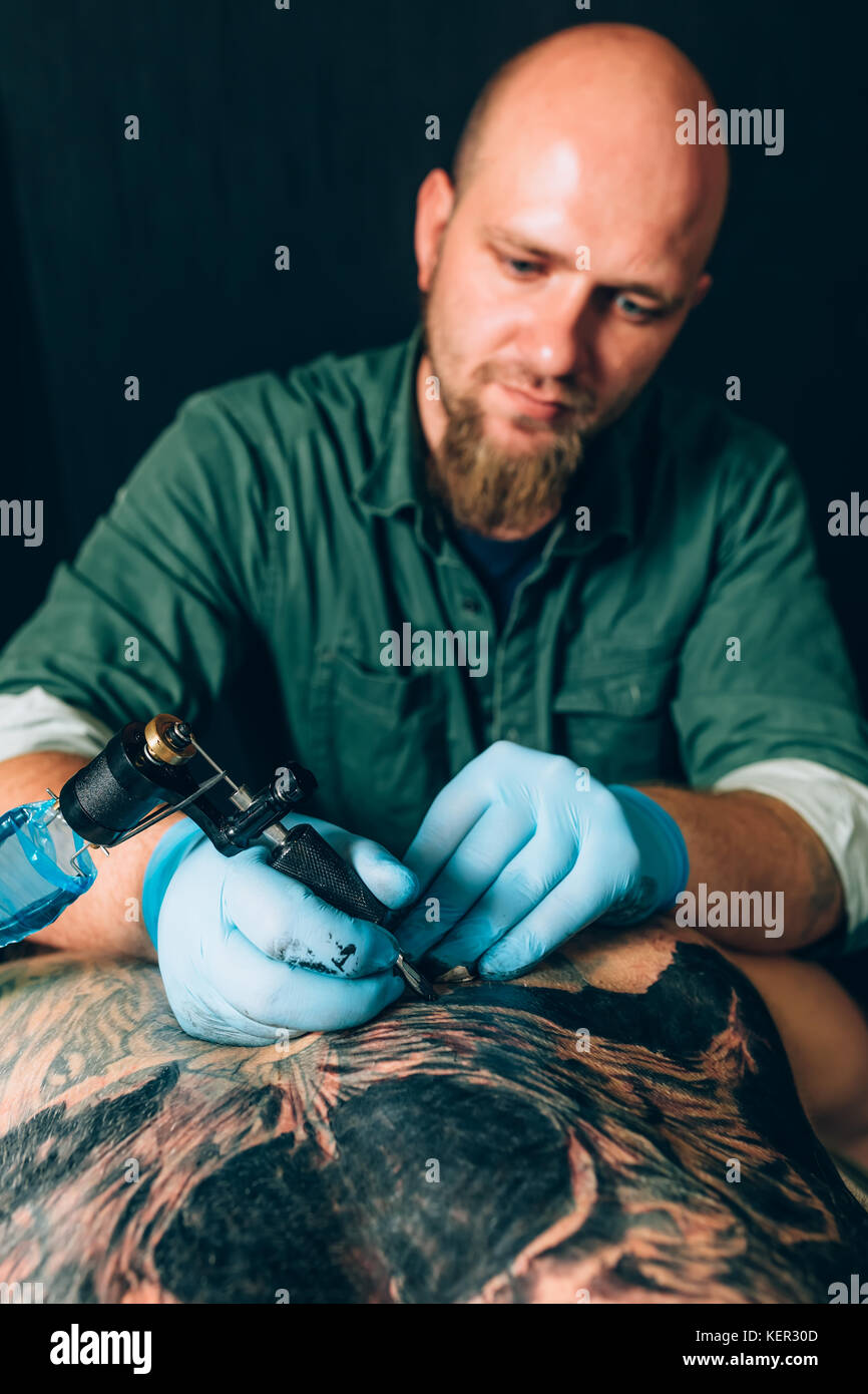 tattoo master artist makes a tattoo. Closeup Stock Photo - Alamy