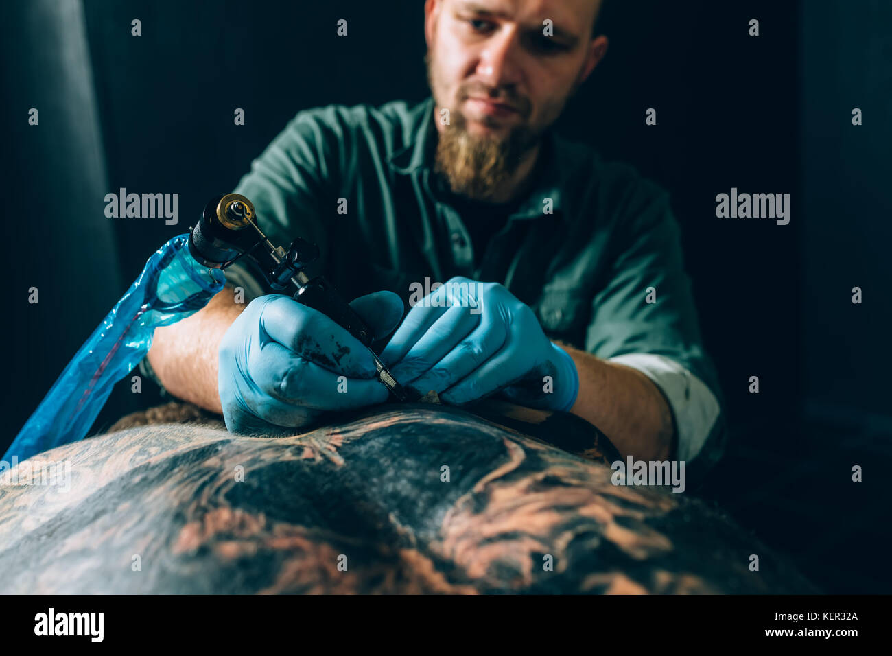 tattoo master artist makes a tattoo. Closeup Stock Photo - Alamy