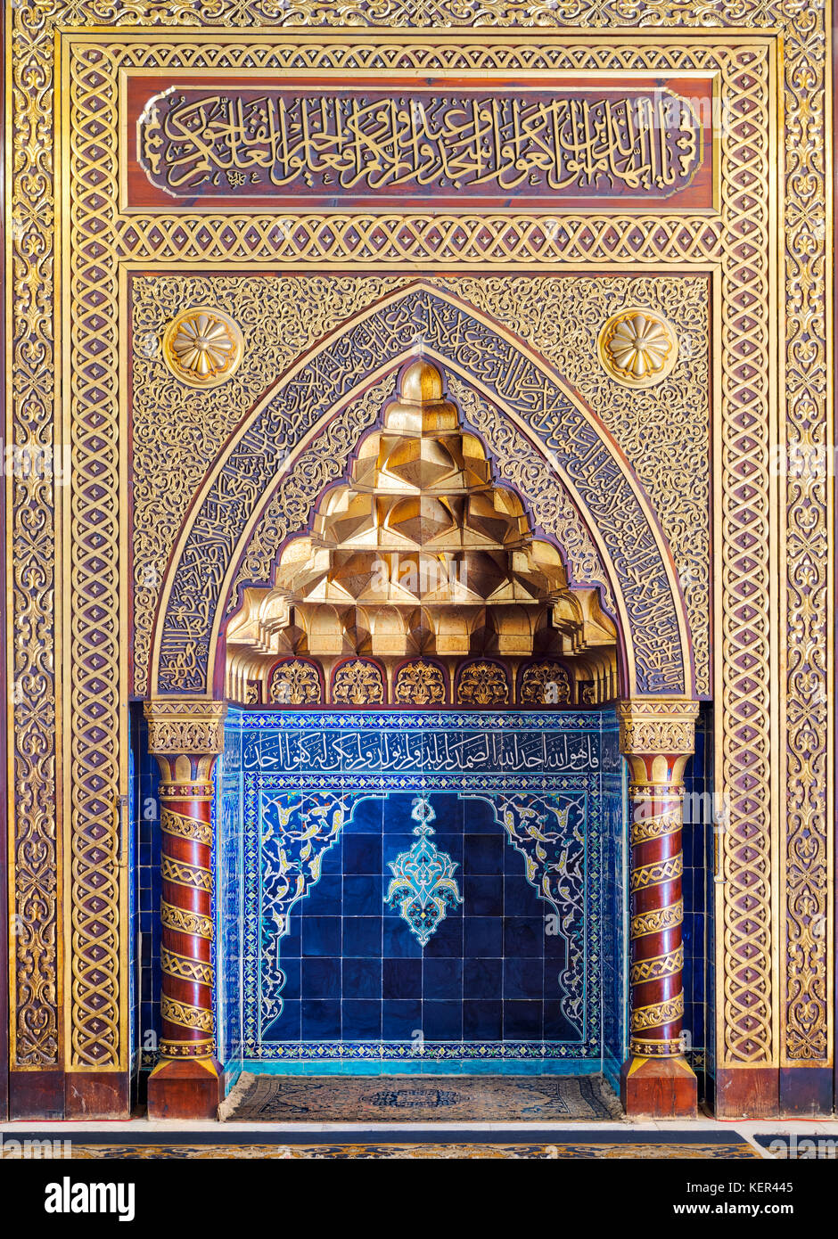 Golden ornate arched mihrab (niche) with floral pattern, blue Turkish ...