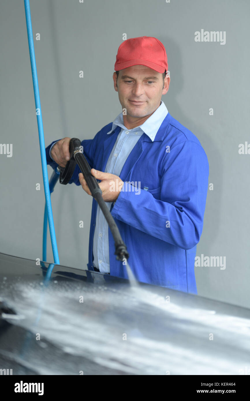 worker cleaning a car with high pressure cleaning Stock Photo - Alamy