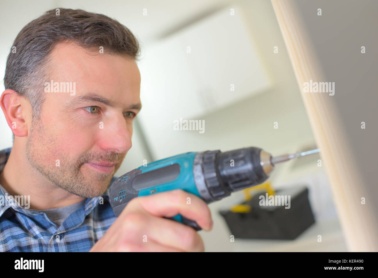 man drilling the wall with drill perforator Stock Photo - Alamy
