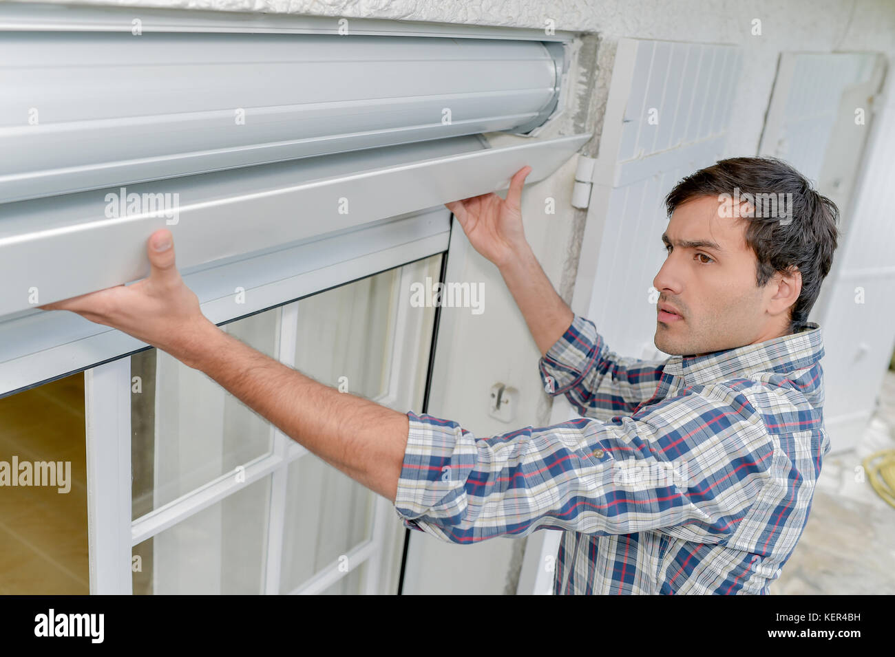 Man fitting a new window Stock Photo - Alamy