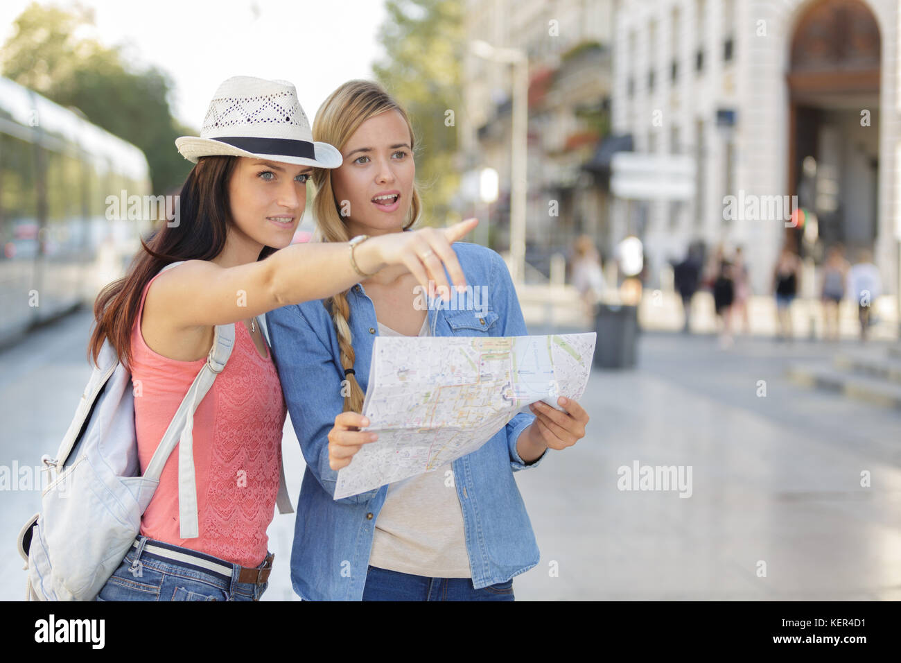 young beautiful woman travelers exploring the city Stock Photo - Alamy