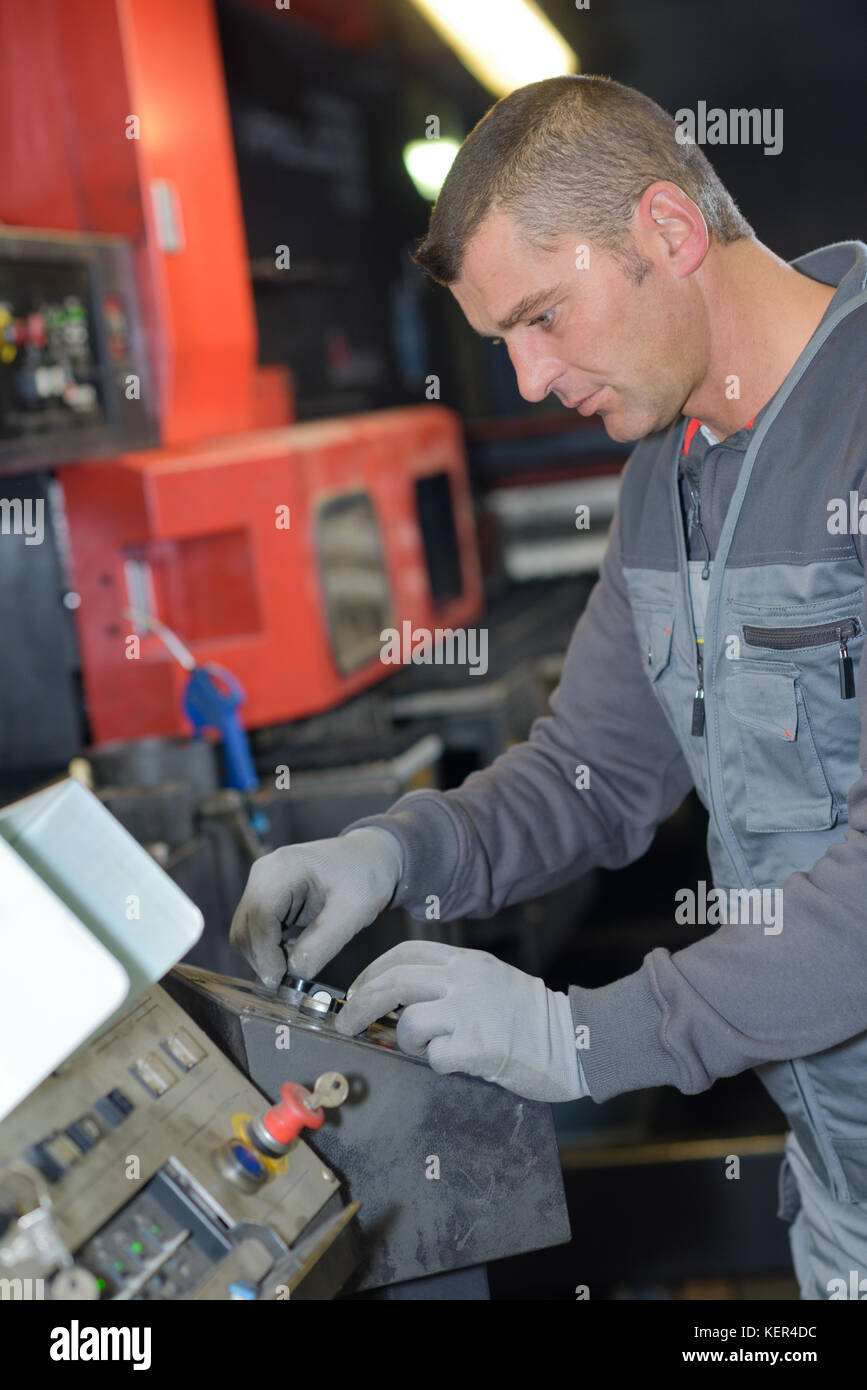 Man operating industrial machinery Stock Photo - Alamy