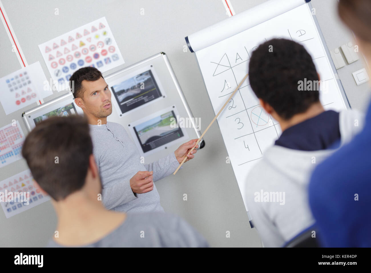 driving instructor pointing at board in a classroom Stock Photo - Alamy
