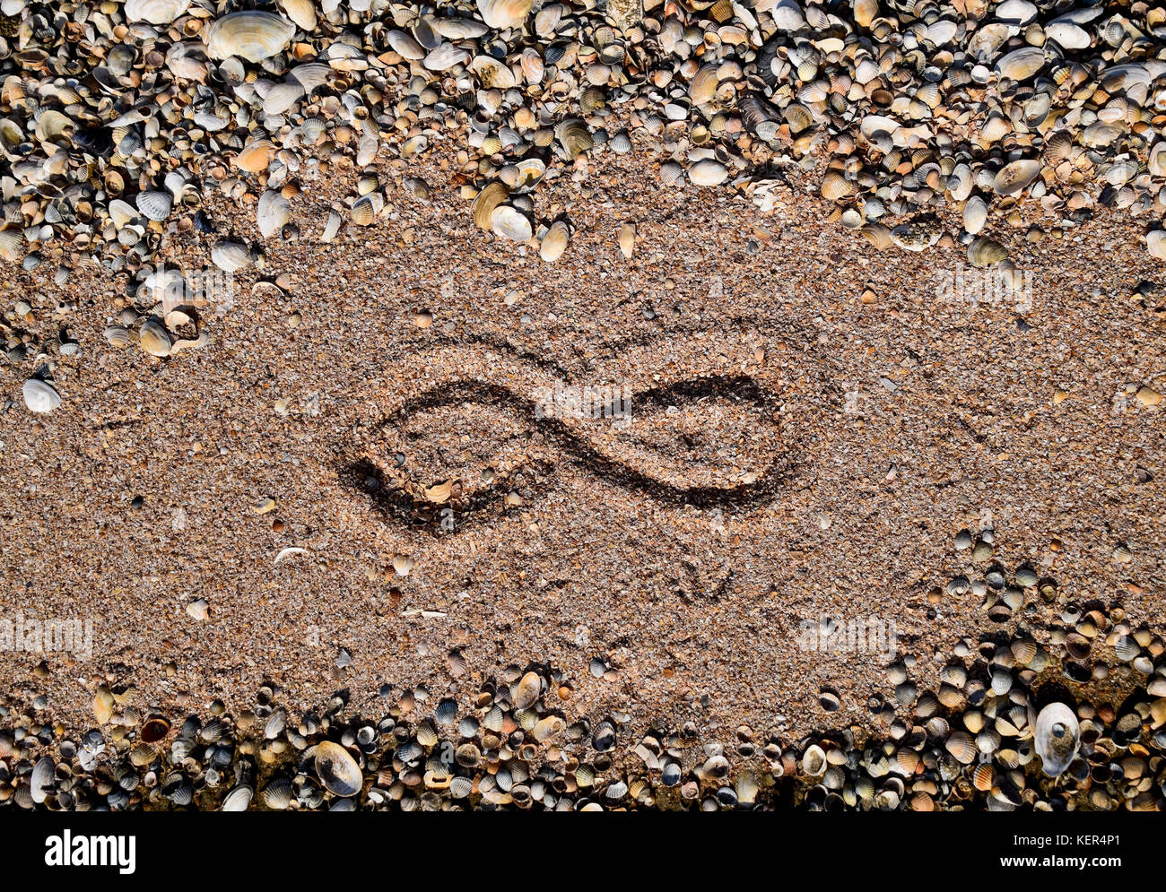 The sign of infinity on the sea. Coastal sand on the beach. The symbol ...