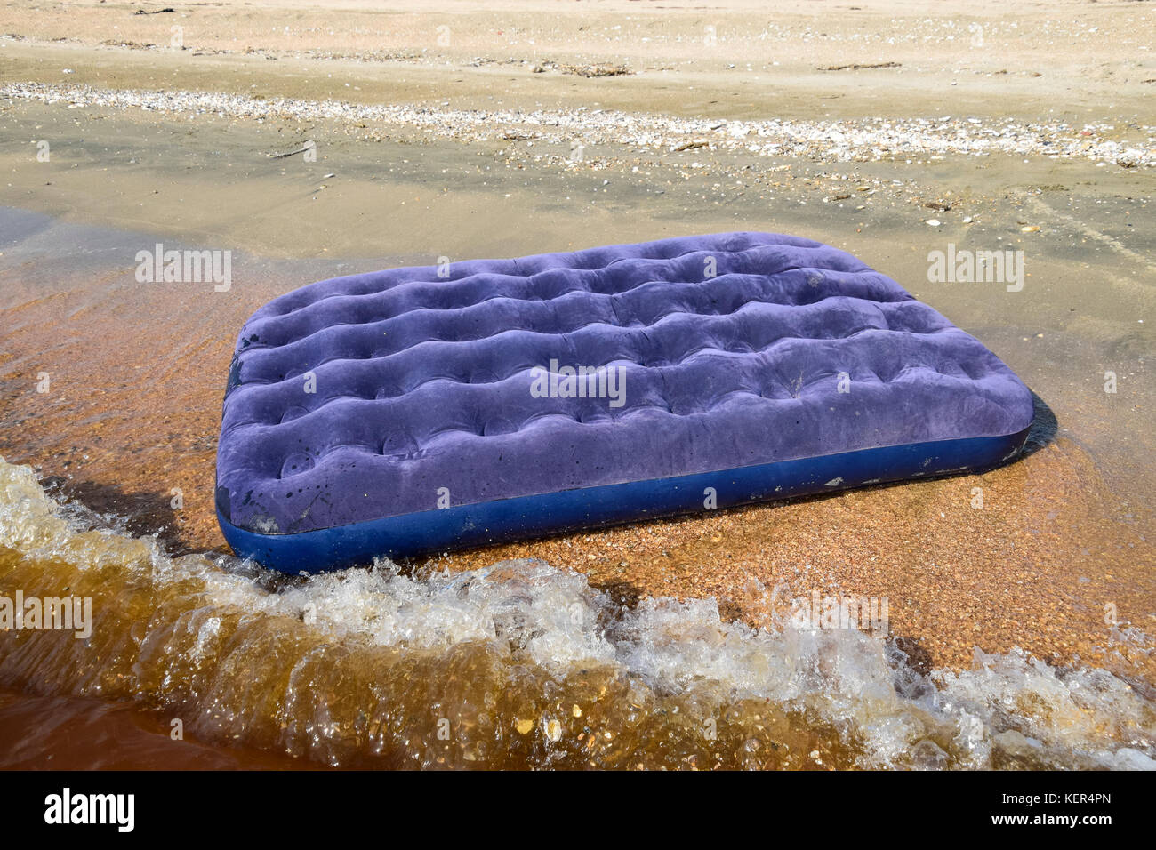 Blue inflatable mattress swimming in the pond. An inflatable mattress ...