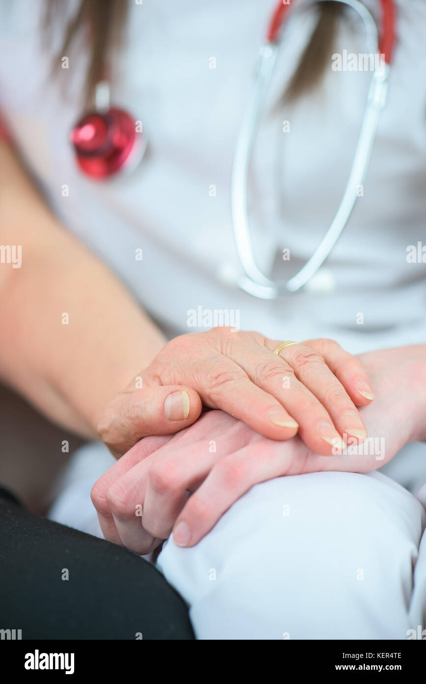 Closeup of hand on top of nurse's hand Stock Photo - Alamy