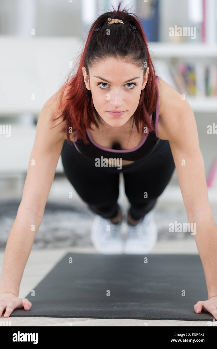sportive woman doing push ups at home Stock Photo - Alamy