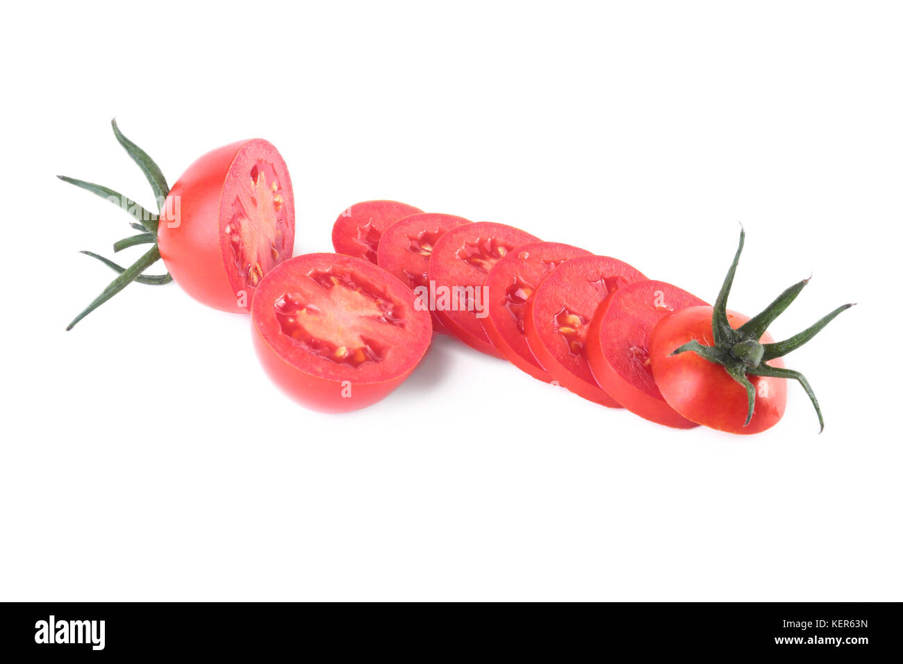 sliced fresh tomatoes with green leaves isolated on white background ...