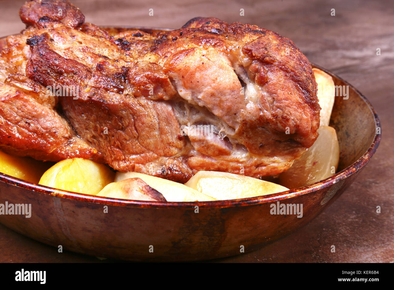 Juicy pork neck chops are grilled with potatoes on a stone Background ...