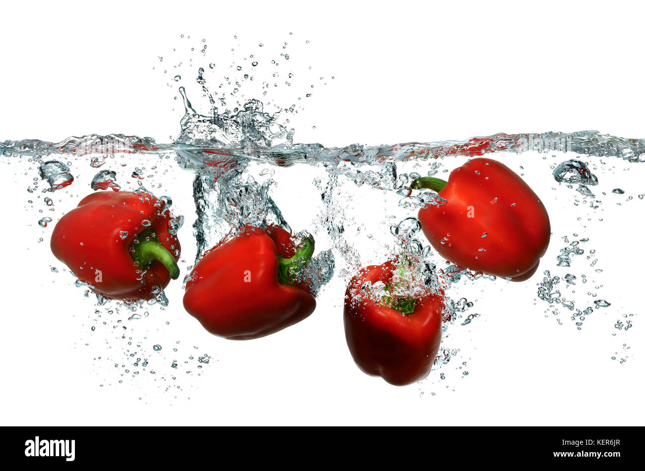 Bright red bell peppers splashing into fresh clean water Stock Photo ...