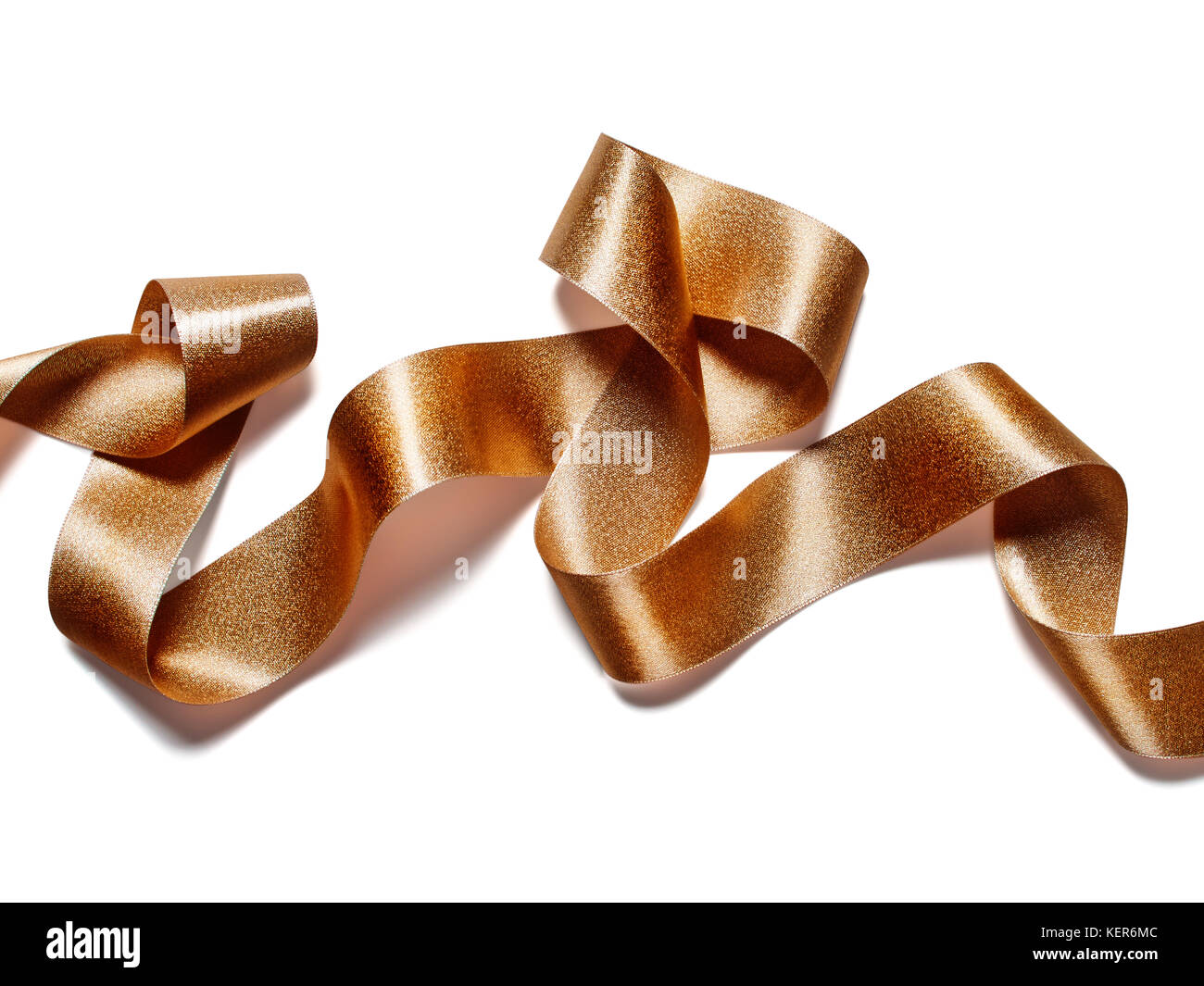 Close up of gold bronze metallic ribbon isolated on white background ...