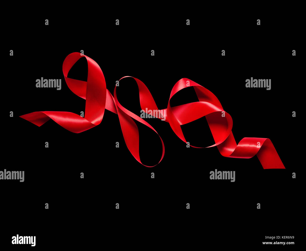 Red satin silk ribbon isolated on black background Stock Photo - Alamy