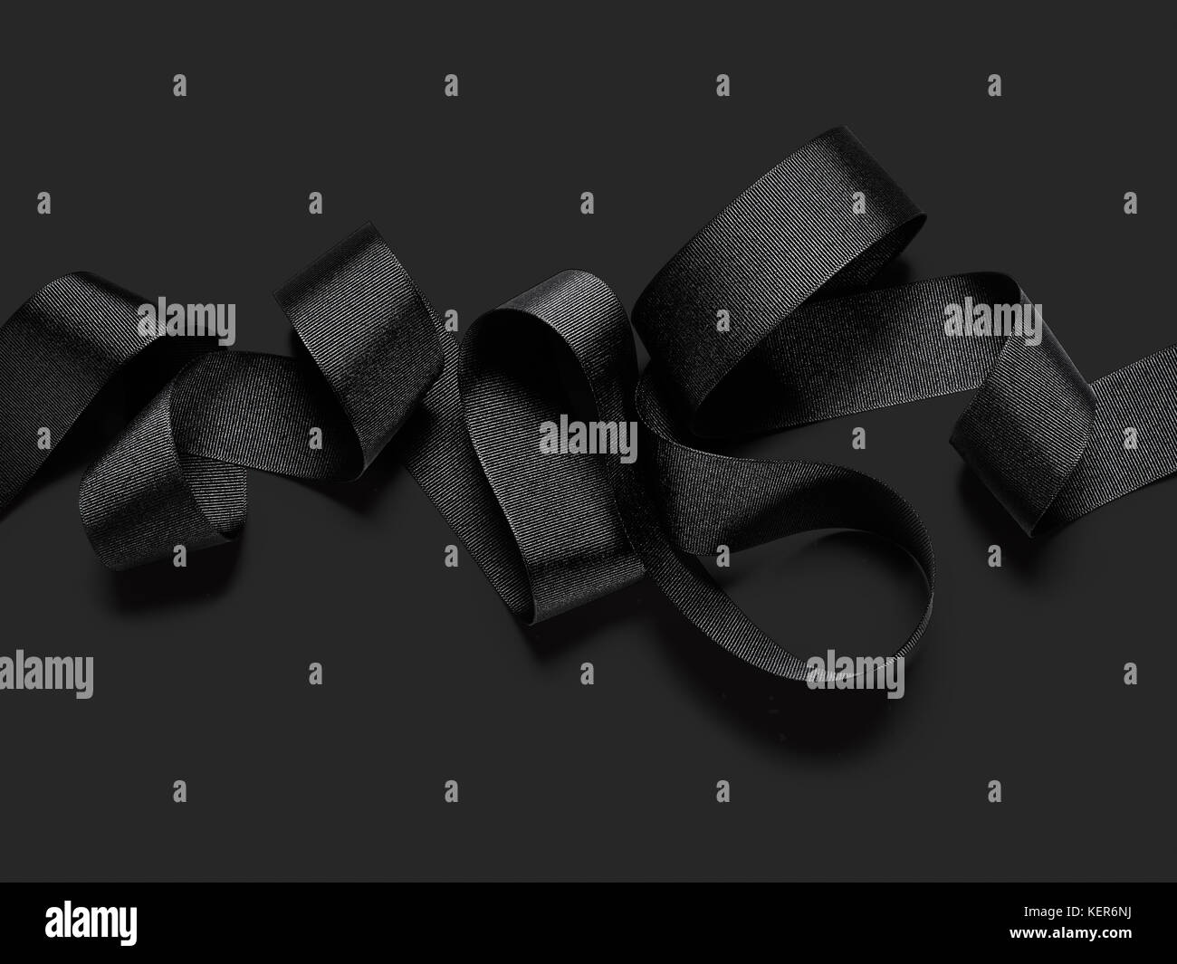 Black ribbon isolated on dark grey background Stock Photo - Alamy