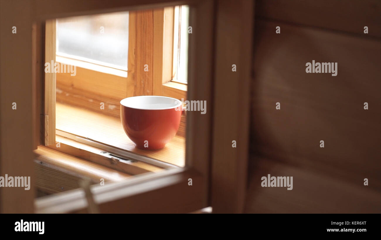 Cup of tea on a wooden window sill. Cup of tea on a wooden windowsill ...