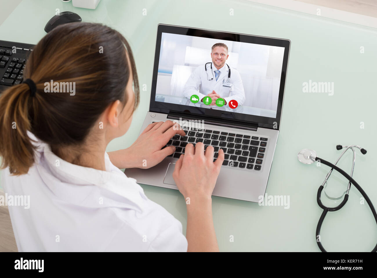 Young Female Doctor Video Chatting On Laptop In Clinic Stock Photo - Alamy