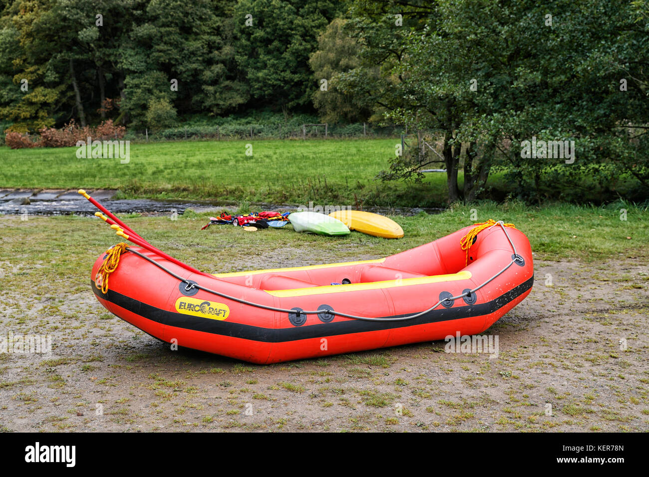 Inflatable raft and Canoes on river bank Stock Photo - Alamy