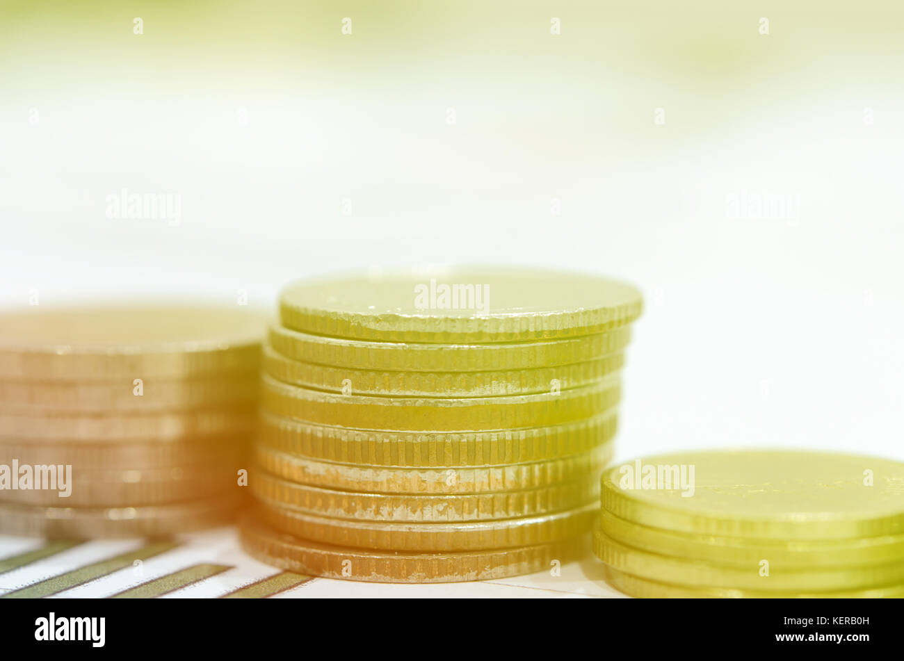 graph and coins on desk Stock Photo - Alamy