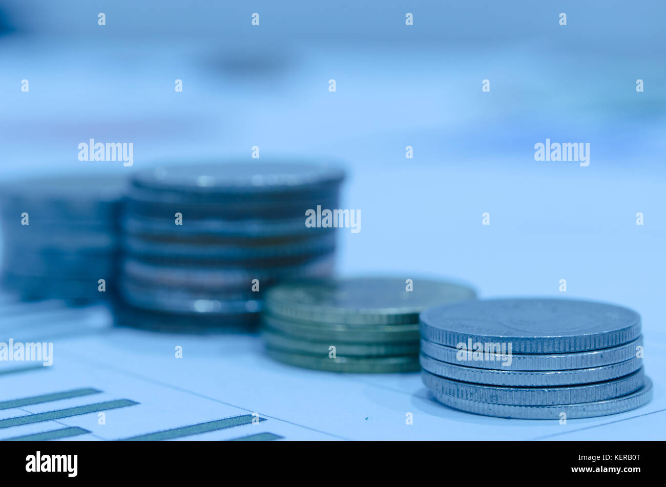 graph and coins on desk Stock Photo - Alamy