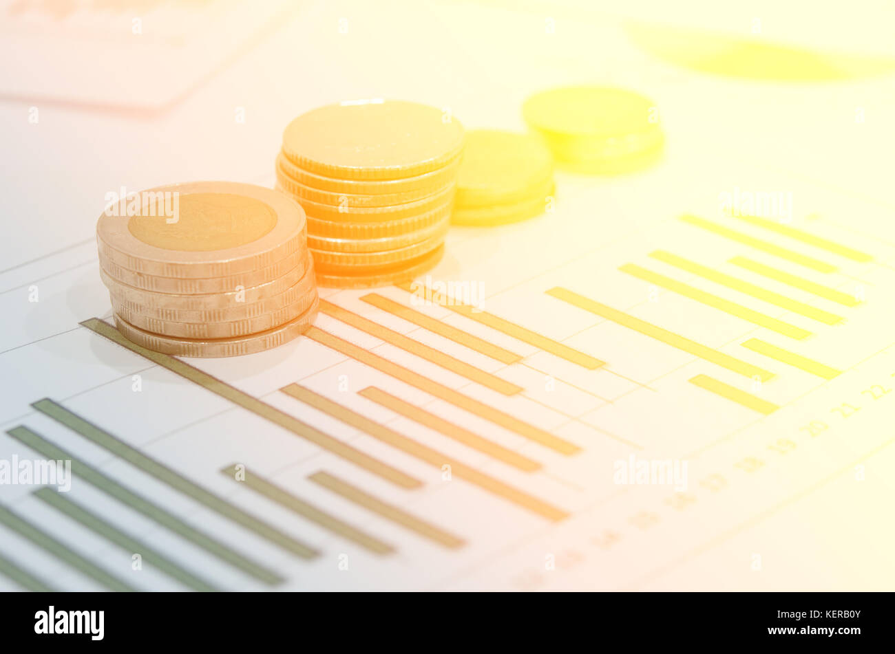 graph and coins on desk Stock Photo - Alamy
