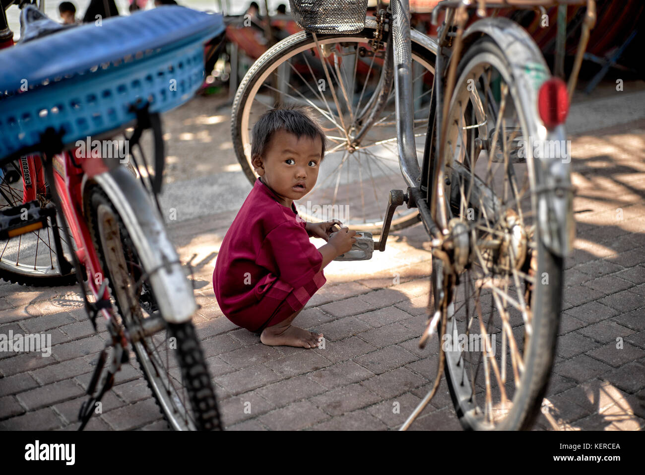 Child playing alone outside. Children playing outdoor. Thailand ...