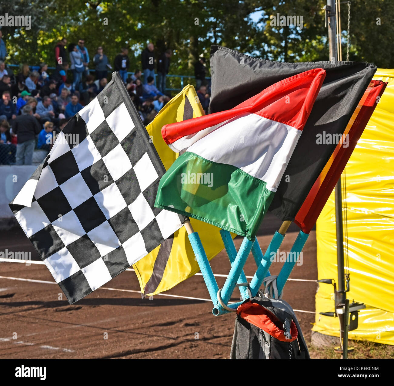 Flags of the speedway race next to the dirty track Stock Photo - Alamy