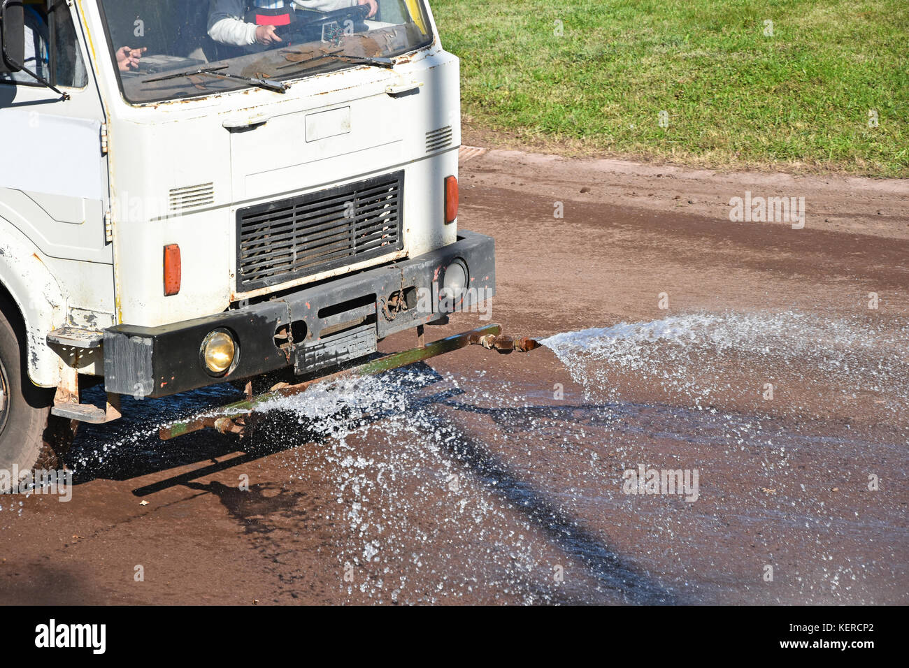 Spraying lorries at work on the dirty sport track Stock Photo - Alamy
