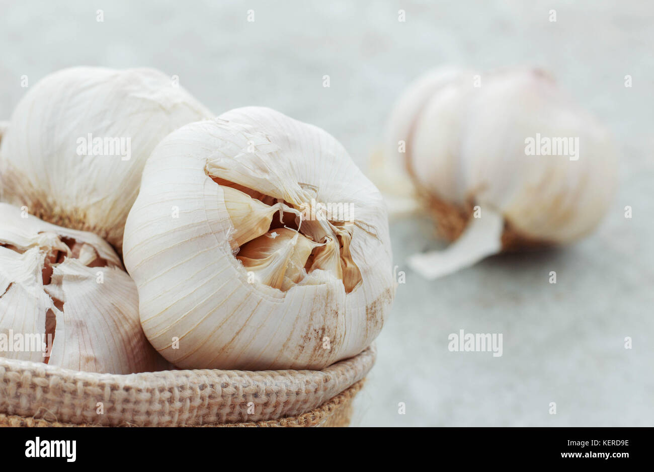 Garlic in a sack on concrete floor Stock Photo - Alamy