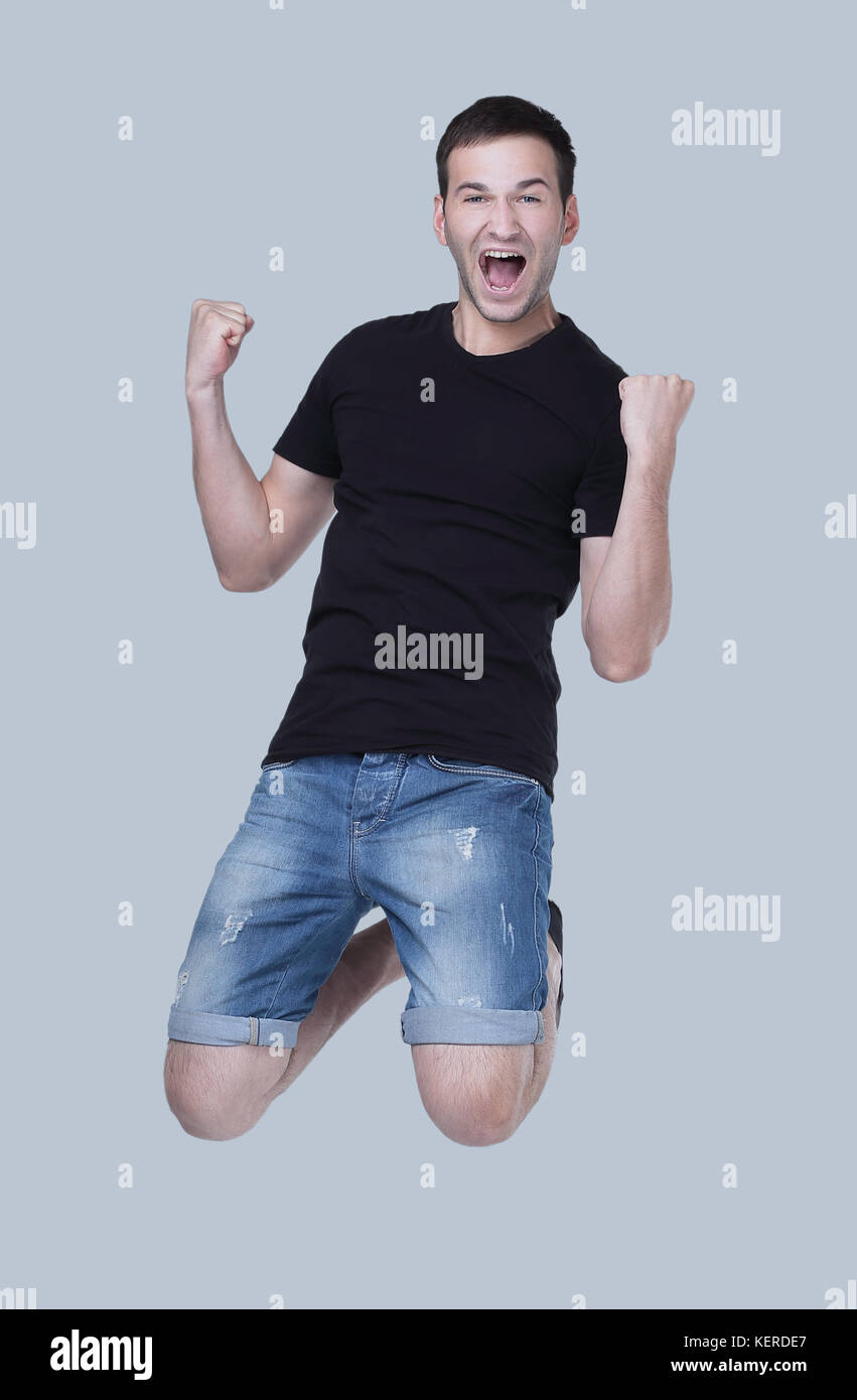Excited young man jumping isolated over a white background Stock Photo ...