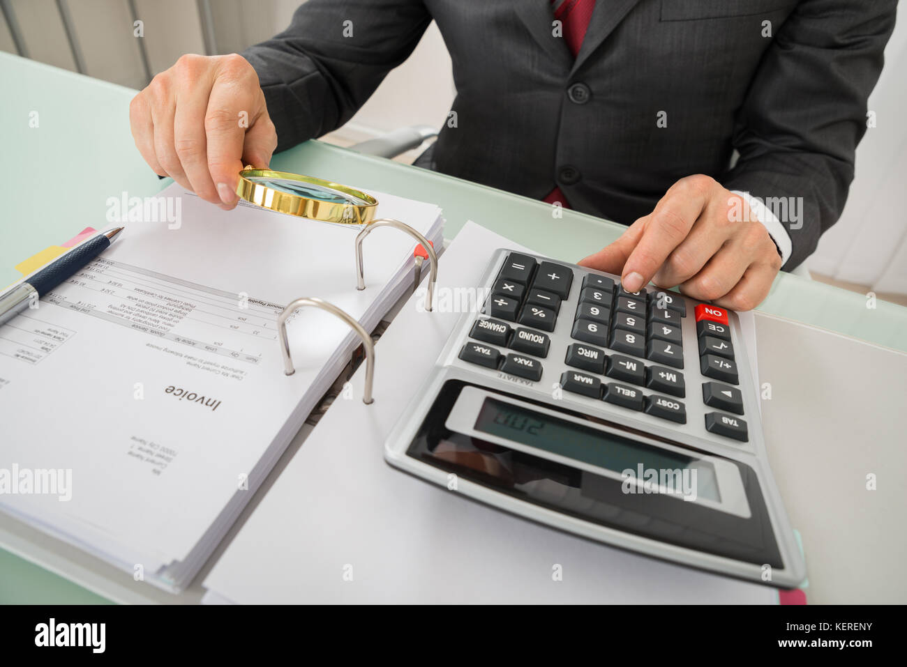 Male accountant using calculator hi-res stock photography and images ...