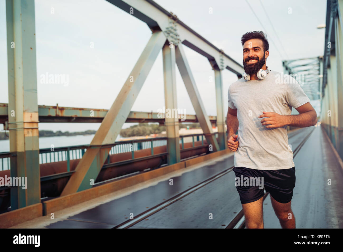 Sporty young man running across hi-res stock photography and images - Alamy