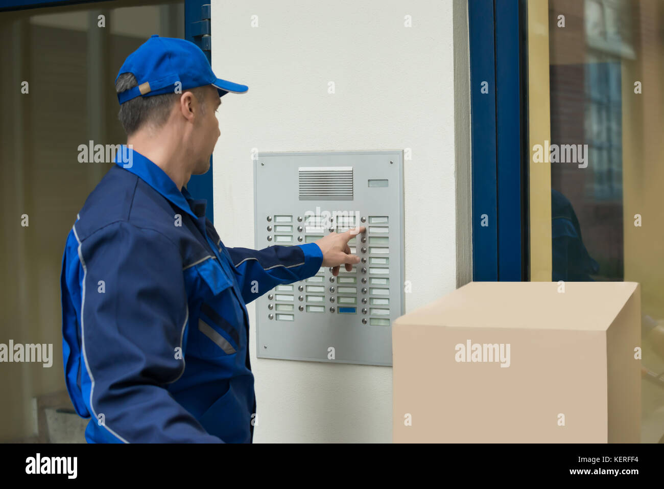 Delivery Man With Trolley Full Of Box Using Security To Enter Building ...