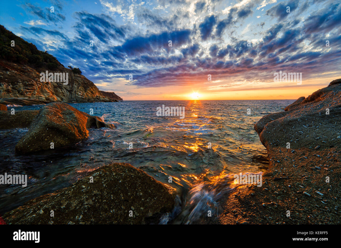 Scenic coastal sunset with orange light on island of Elba Stock Photo ...
