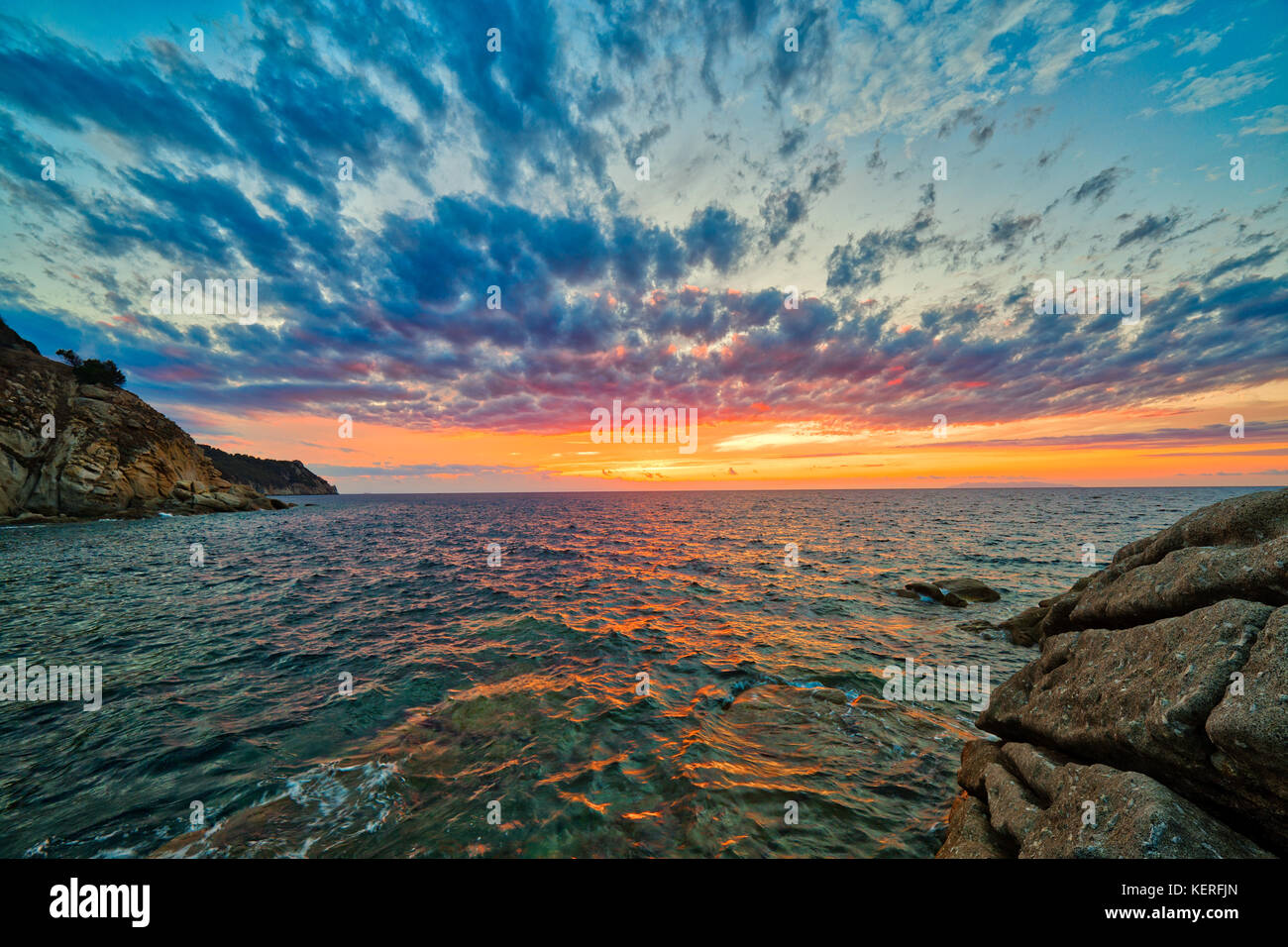 Scenic coastal sunset with orange light on island of Elba Stock Photo ...
