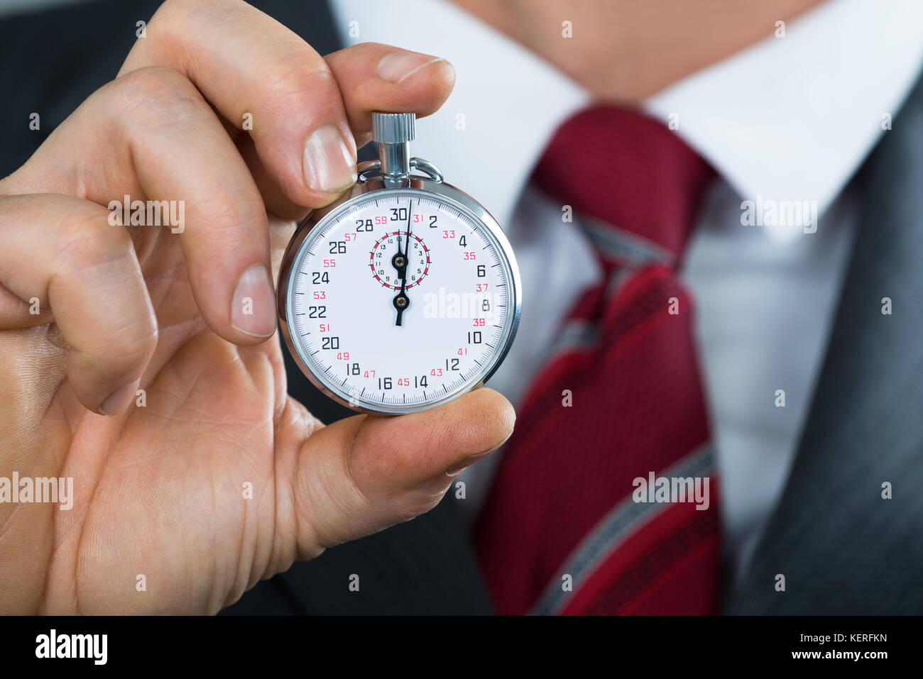 Close-up Of Business Man Holding Stop Watch In His Hand Stock Photo - Alamy