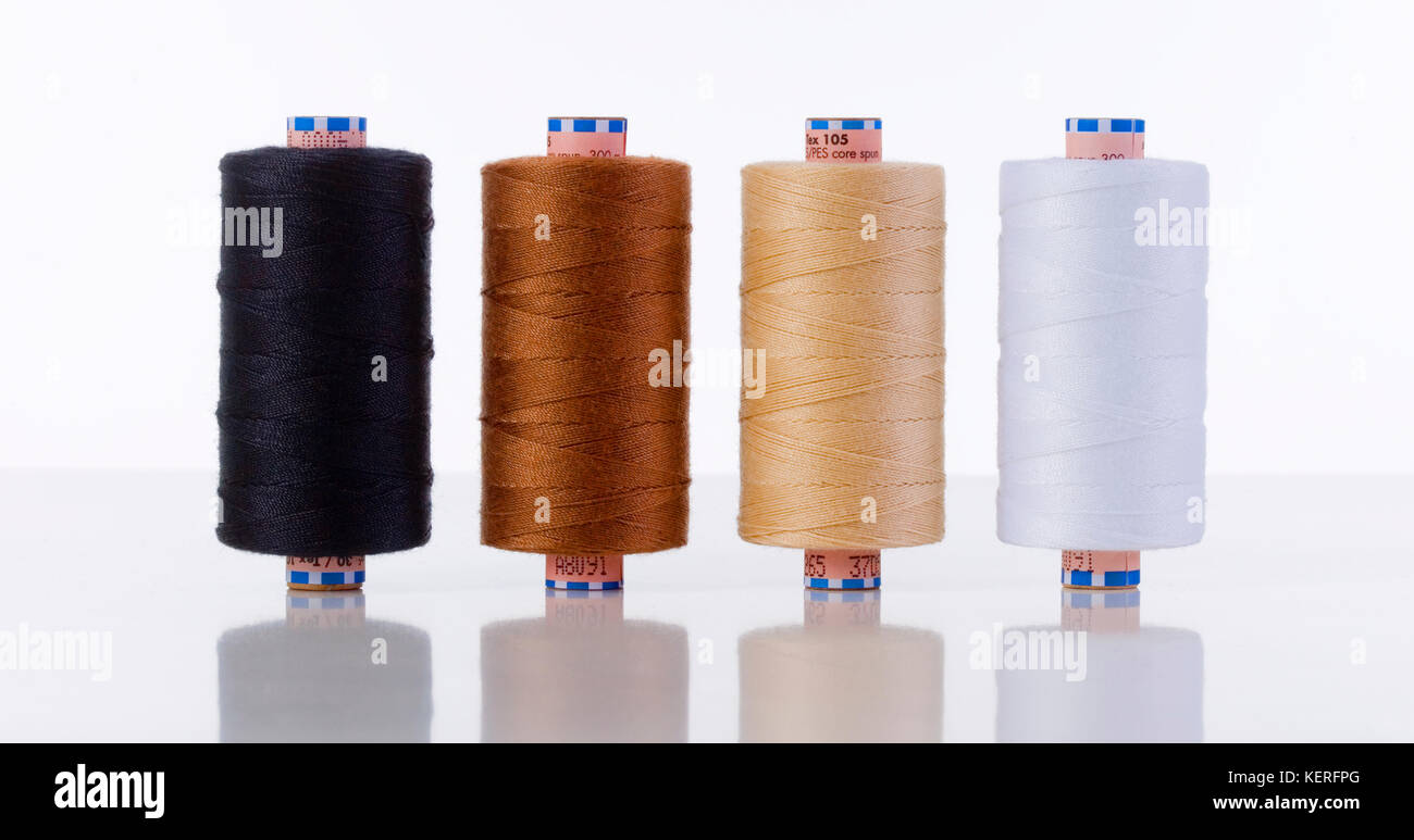 Four Sewing Thread Reels of Different Colors on White Stock Photo - Alamy