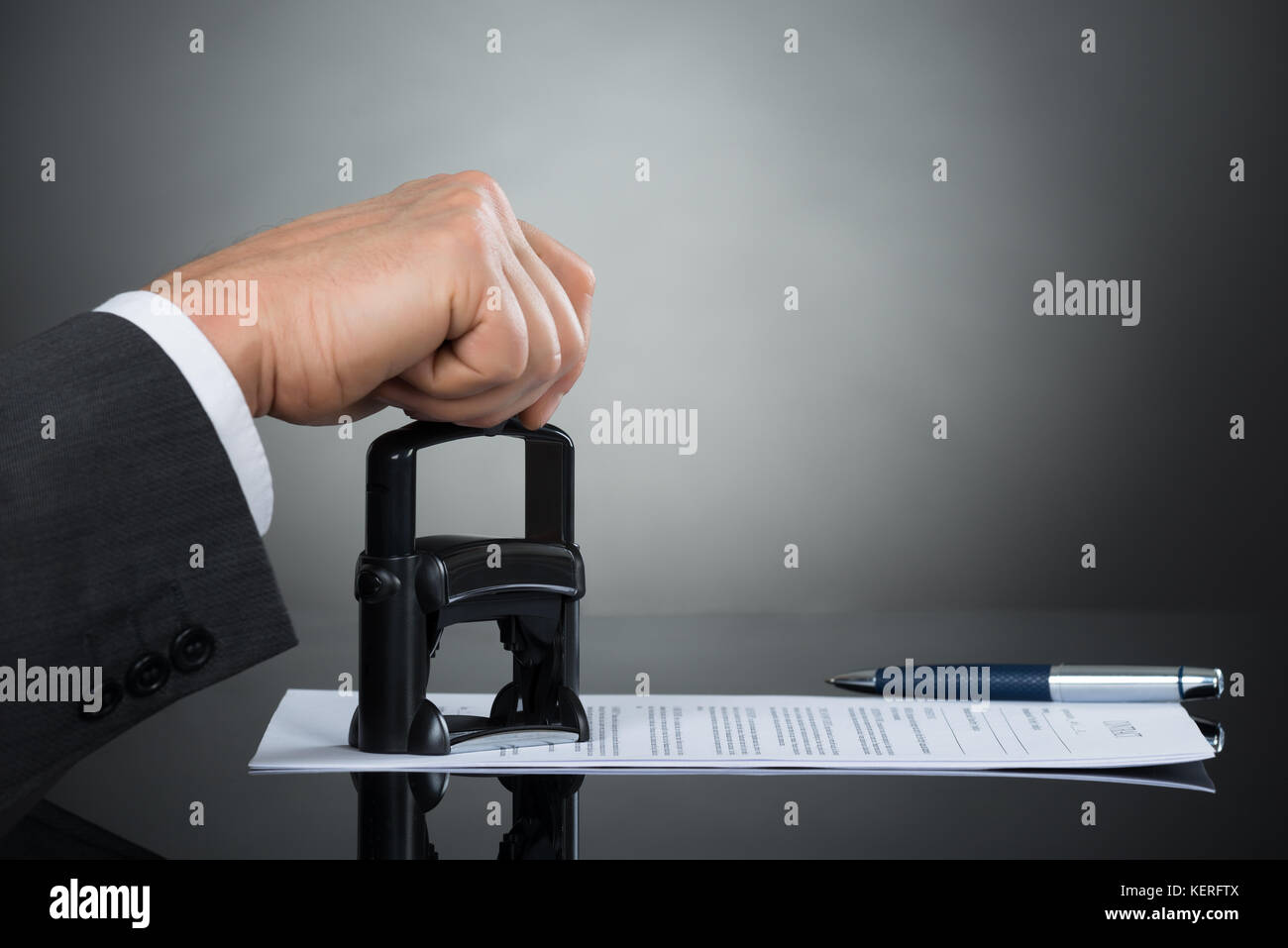 Close-up Of Businessman Hand Stamping Contract Document At Office Desk ...