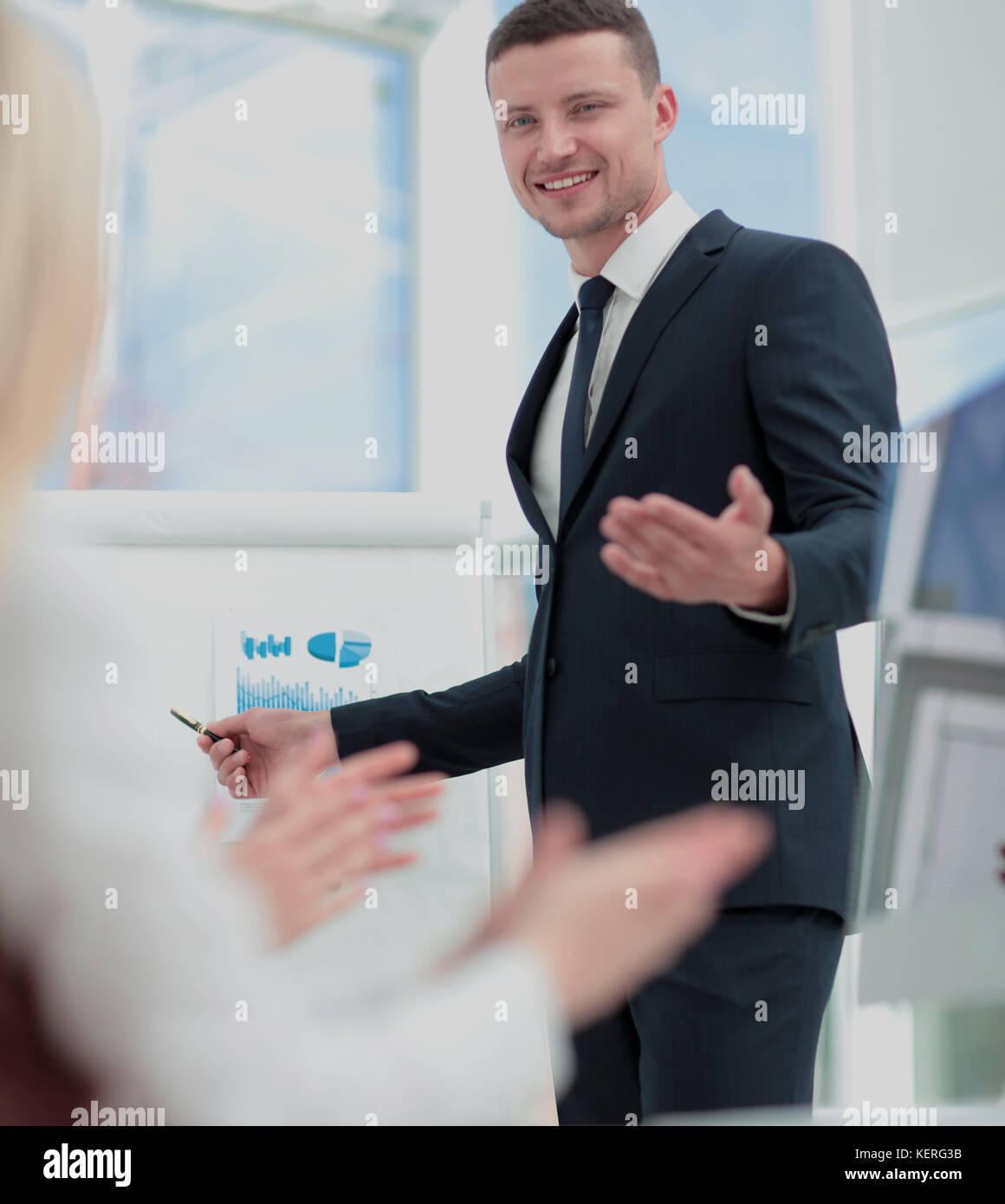 Attractive man making a business presentation to a group Stock Photo ...