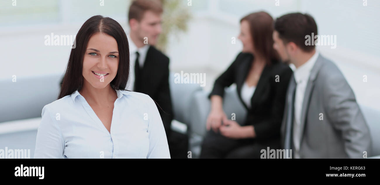 Successful business woman standing with her staff in background Stock ...
