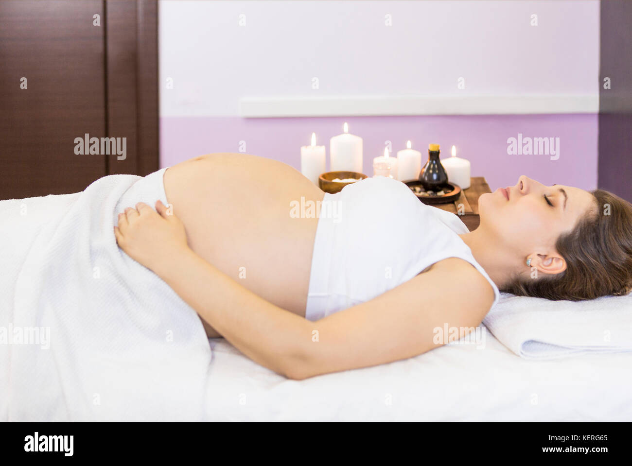 Young pregnant woman have massage treatment at spa salon Stock Photo - Alamy