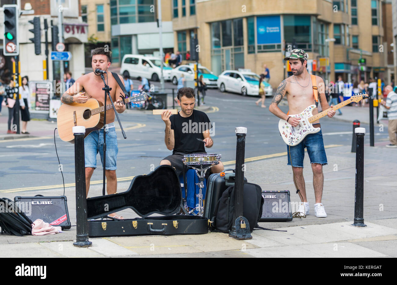 Group of male shirtless buskers singing in the city in Summer in ...