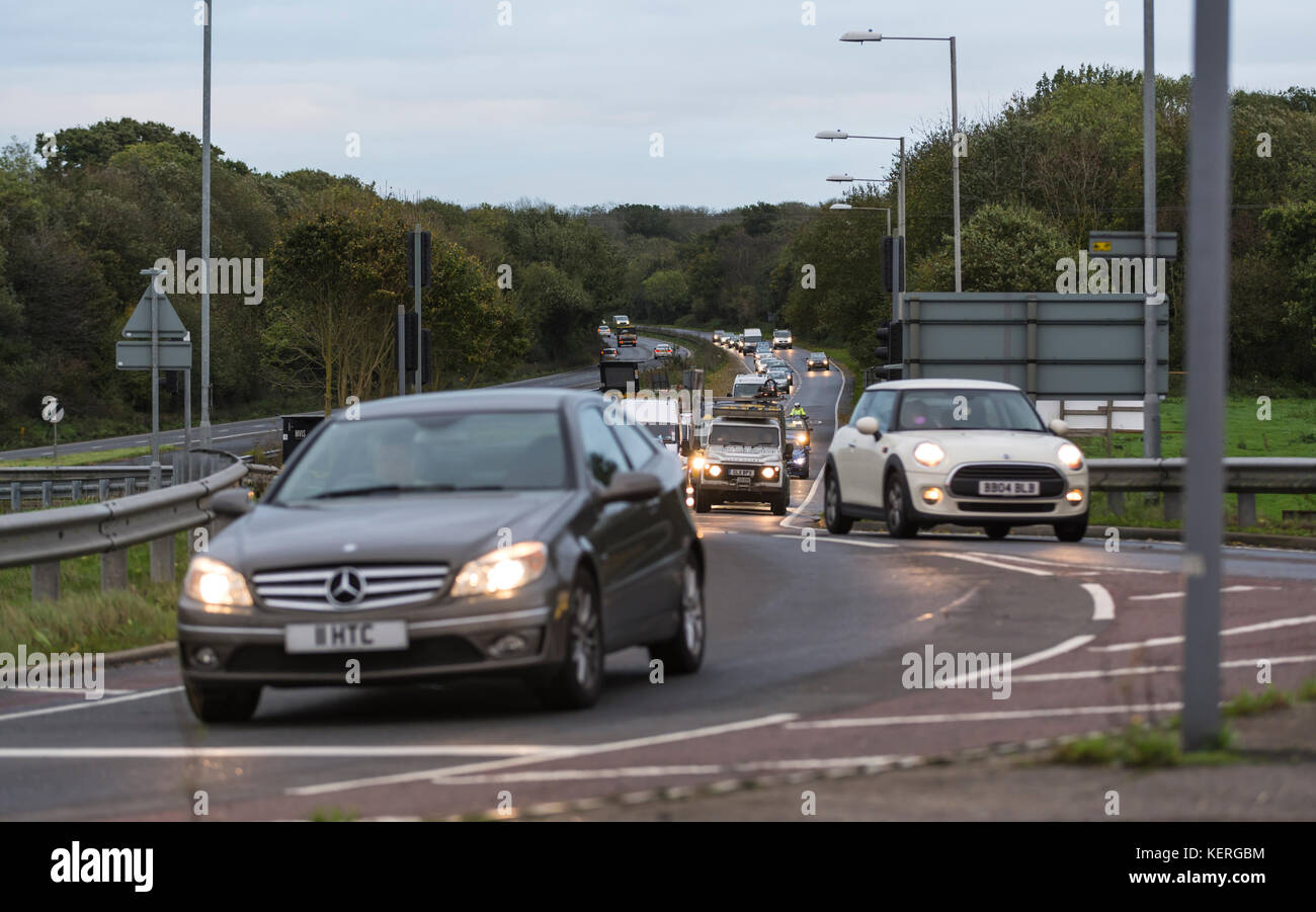 Cars with lights on in traffic being driven to work in the early ...