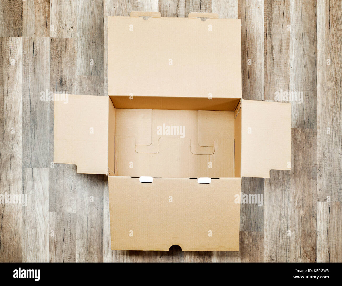 Opened box on the floor Stock Photo - Alamy